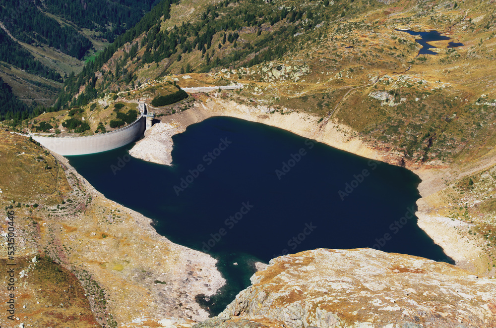 Alpine dam and Lake Publino, Valtellina, Italy. View from high peak ...