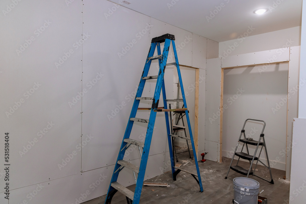 Plasterboard is being installed in a room with drywall is ready for ...
