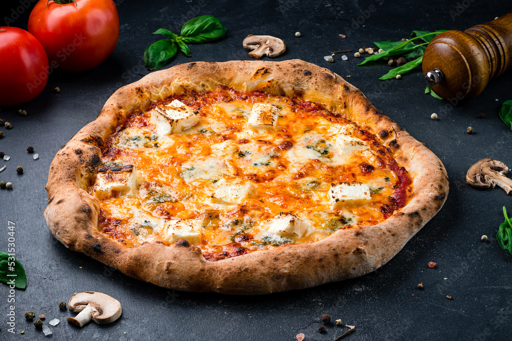 Traditional italian pizza four cheese on black background. Quattro formaggi pizza with four ...