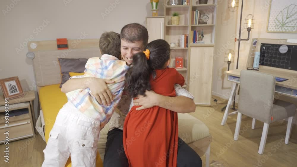 The children run and hug their father. Children running and hugging ...