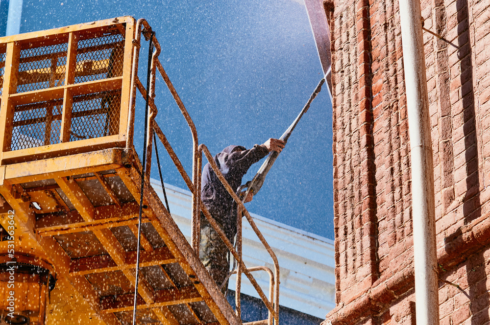 Water jet cleaning of facades. High pressure washing of the facade of a ...