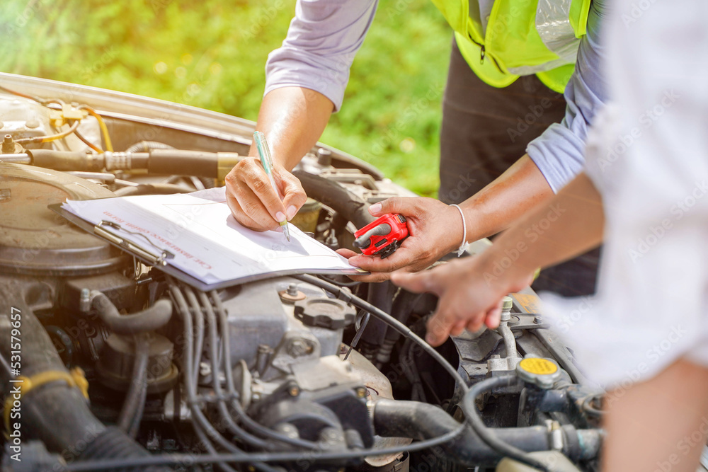 Closeup and crop auto repair checking engine and post a list of repairs ...