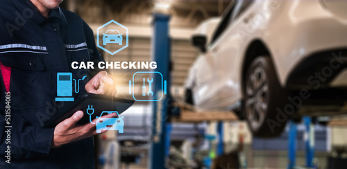 Asian man fix Technology AI fix car repair on car Lift in garage ...