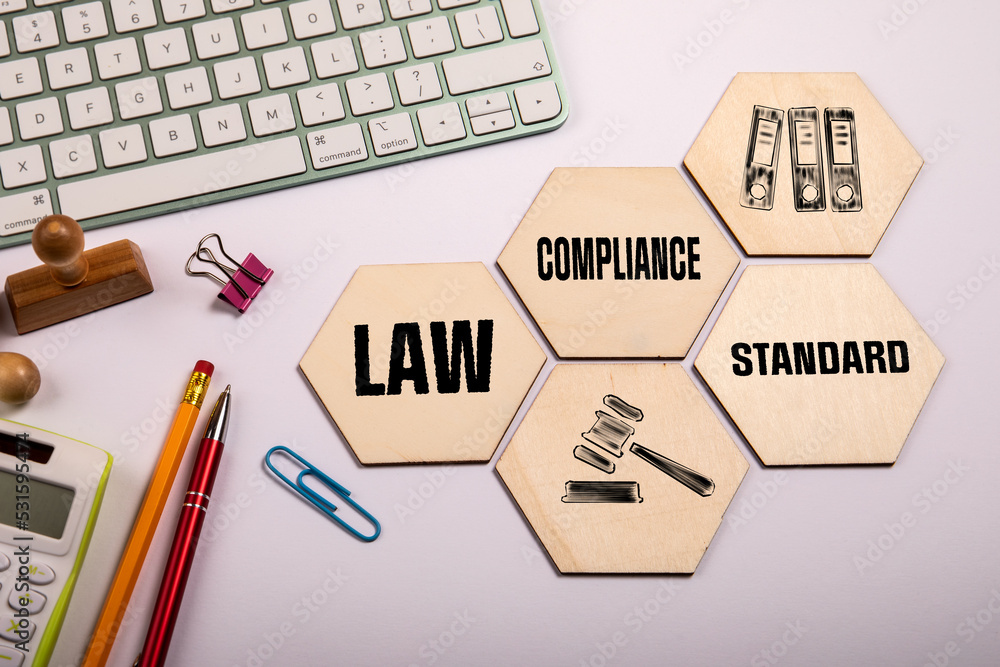 REGULATION CONCEPT. Computer keyboard and stationery on a white office ...