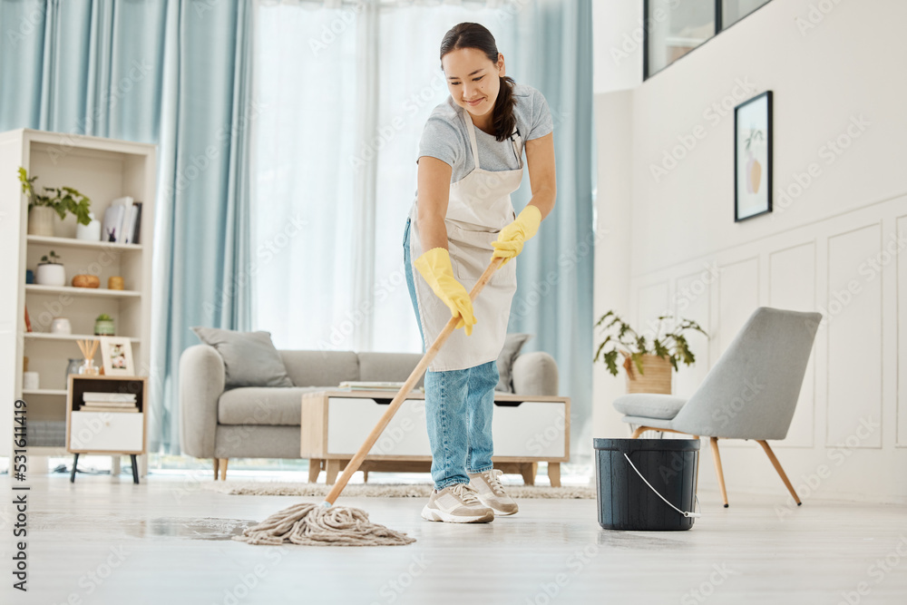 Woman Cleaning The Floor With A Mop In The Living Room In Home With A