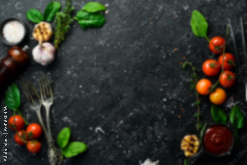 Defocused food background. Black stone cooking background. Spices and ...