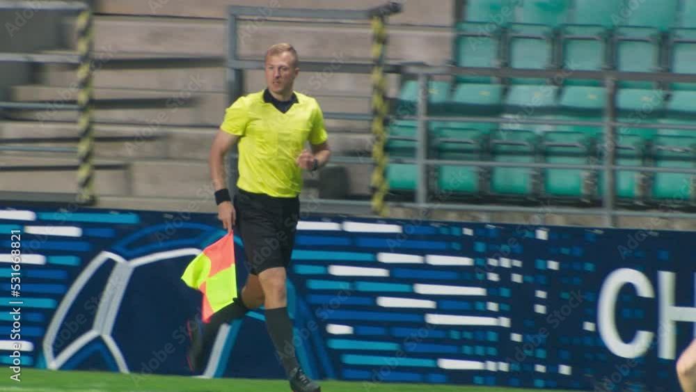 Soccer Football Match Championship: Referee Running on the Field with a ...