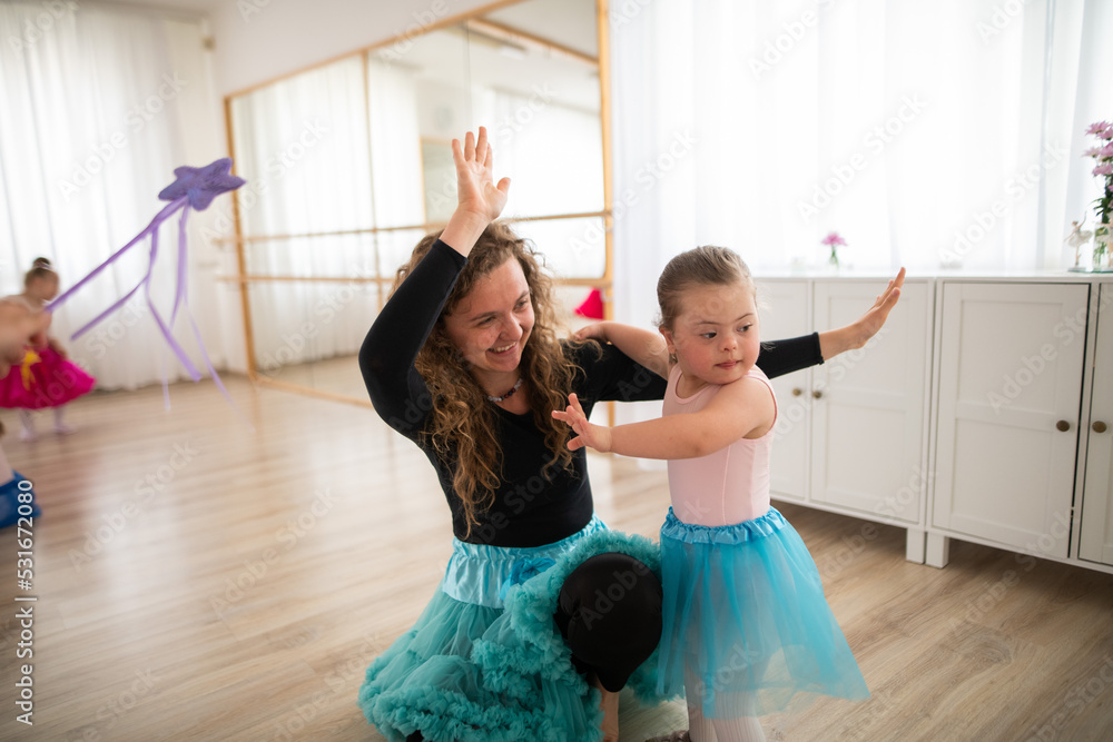 Little girl with down syndrome learning ballet with dance lecteur in ...
