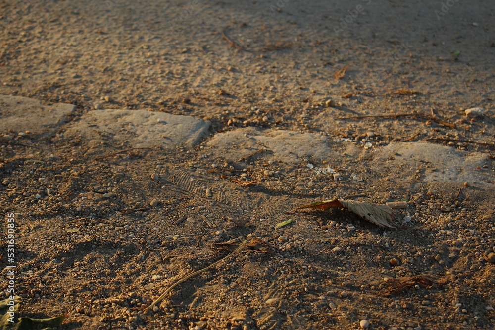 Footprints on a gravel path - Gravel path in a park on a late summers ...
