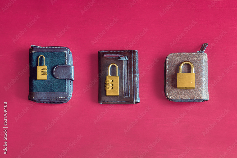 Three different wallets with different golden padlocks and locks on top ...
