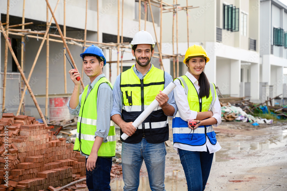 Group of happy contractors, engineers and formats in safety vests with ...