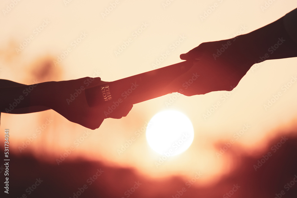 Hands delivering the holy bible and church evangelism concept to spread ...