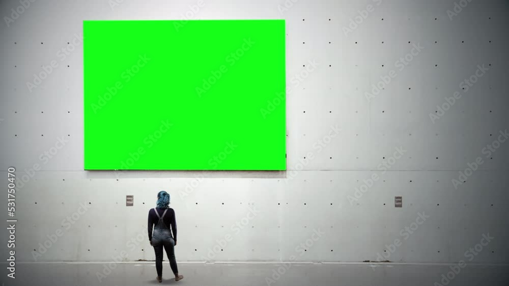 Girl Looking Up Panel Green Screen On Wall. Woman looking up to a green ...