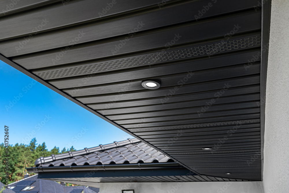 A modern graphite roof lining is attached to the trusses, visible ...