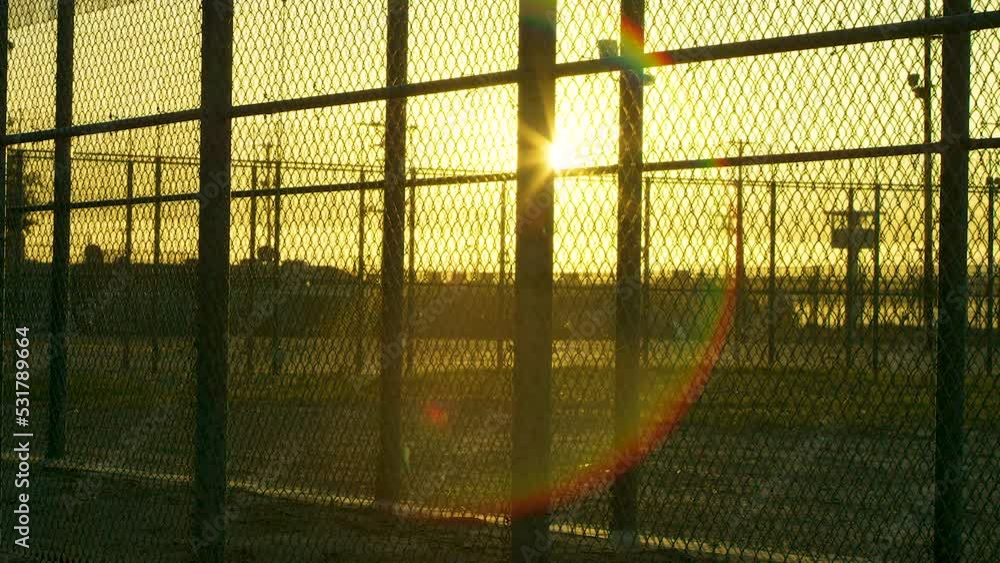 Overview of the electric chain-link fence with barbed wire of the ...