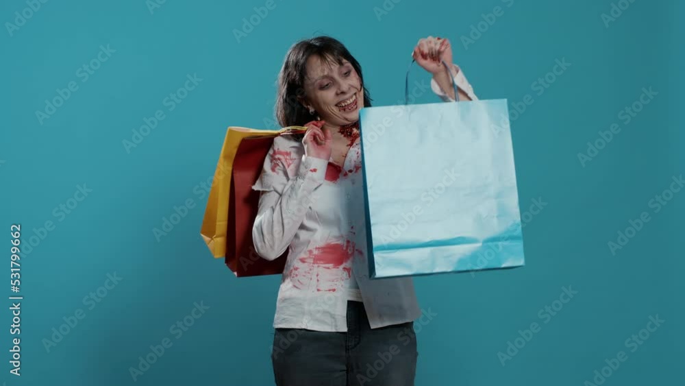 Vidéo Stock Sinister frightening zombie with colorful shopping bags ...