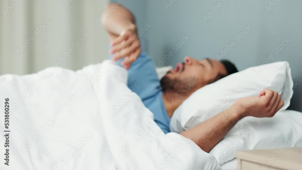 Tired man with alarm clock in bed waking up on Monday morning for ...