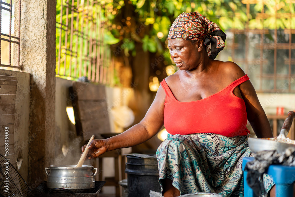 image of african woman with a cooking pot- black mother preparing local ...
