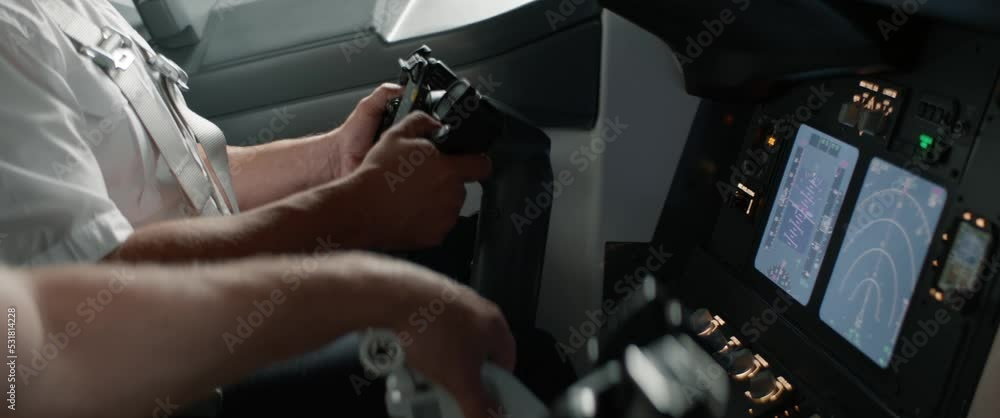 Commercial aircraft pilots adjusting flight parameters of the plane ...