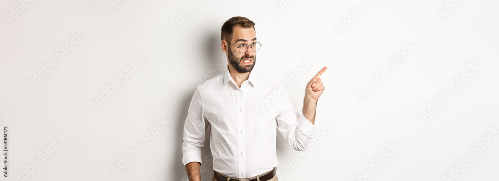 Young bearded guy seeing something disturbing, cringe while pointing ...