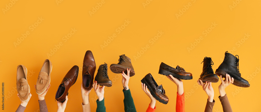 Many hands with different stylish shoes on orange background 스톡 사진 ...