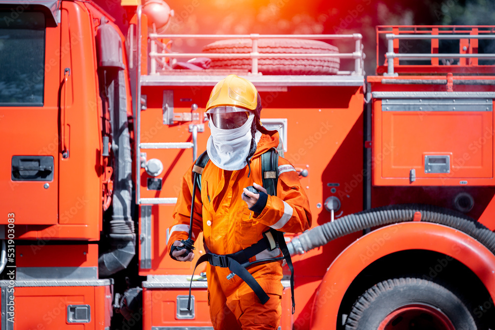 Firefighter man wearing protective fire suite and helmet with equipment ...