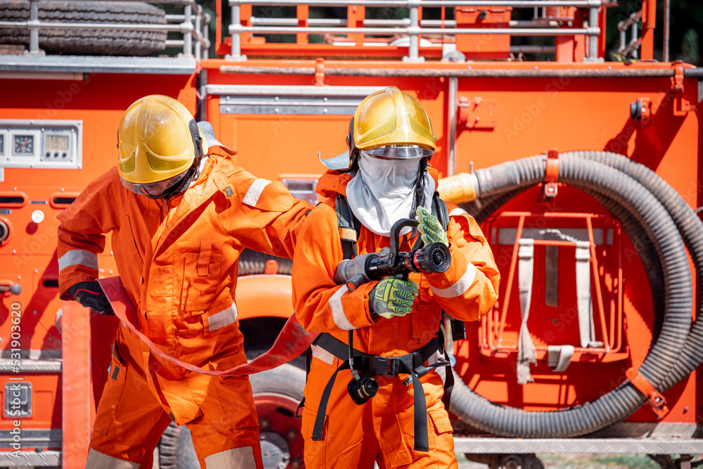 Firefighter man wearing protective fire suite and helmet with equipment ...