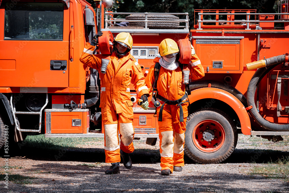 Firefighter man wearing protective fire suite and helmet with equipment ...