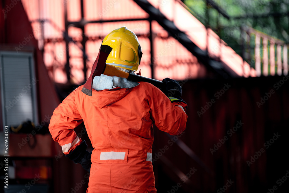 Firefighter man wearing protective fire suite and helmet with equipment ...