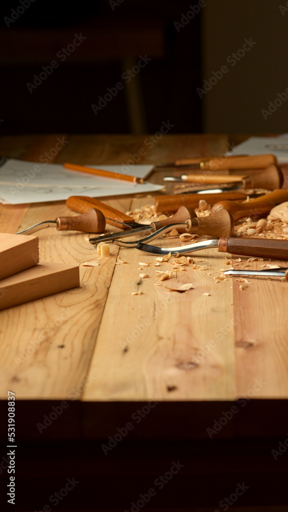 Woodworking table and lot of tools and wood plank. Carving wood with ...