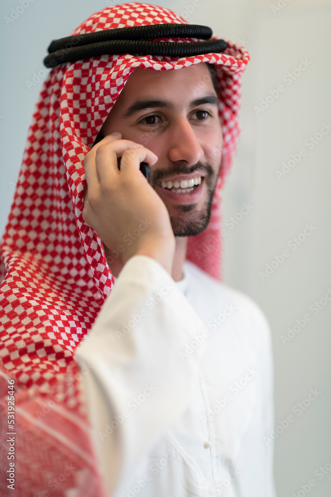 Young modern Muslim Arabian businessmen wearing traditional clothes ...