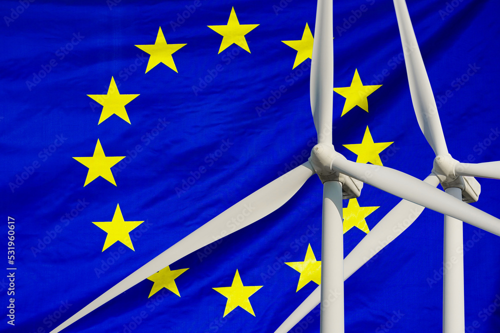 Foto de Two Wind Turbines for alternative energy on EU flag background ...