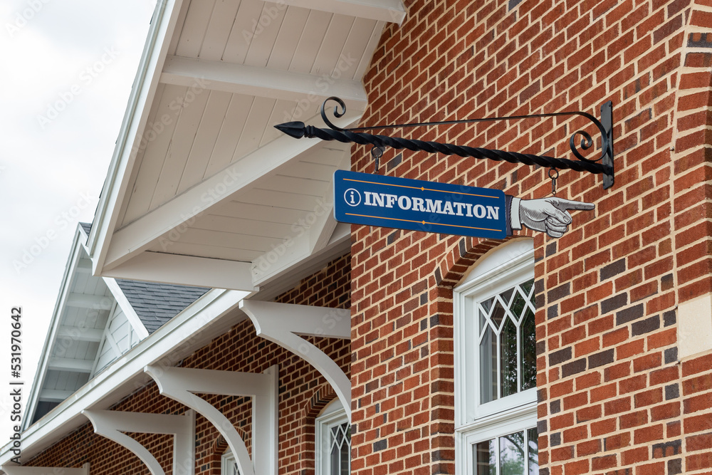 The exterior of a red and brown brick building with a white overhang ...