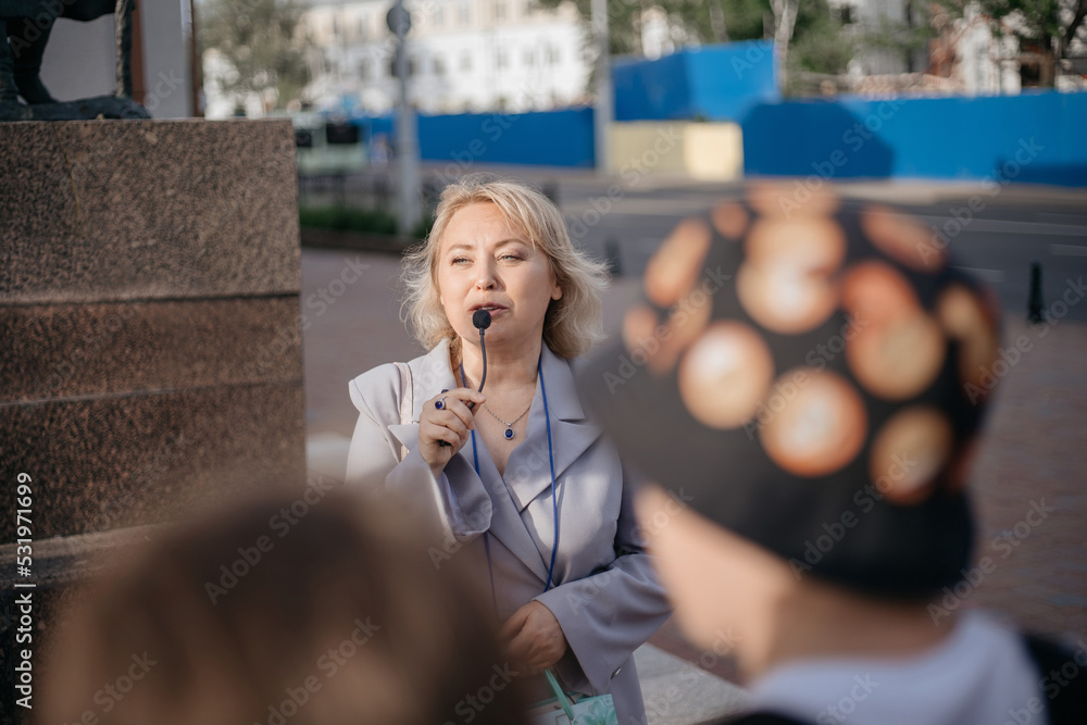 female guide conducts an excursion for foreign tourists. Stock Photo ...