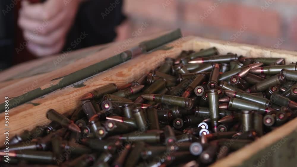 Hand takes ammo, bullets 7.62 caliber for ak47 closeup, gun crime ...
