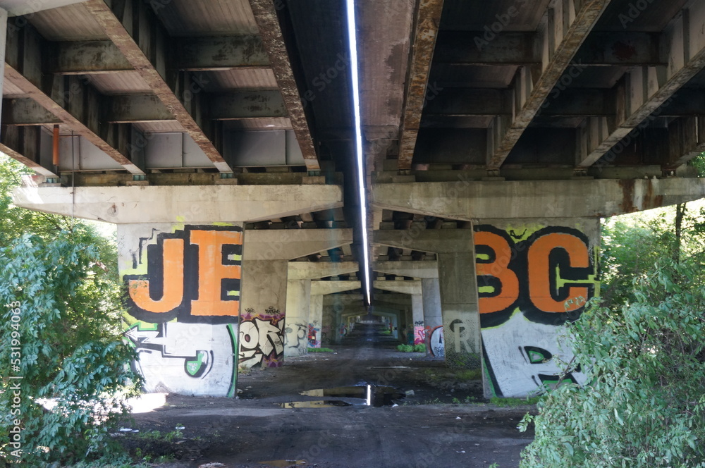 Under highway bridge. Separating line of light. Bridge piers. Silesia ...