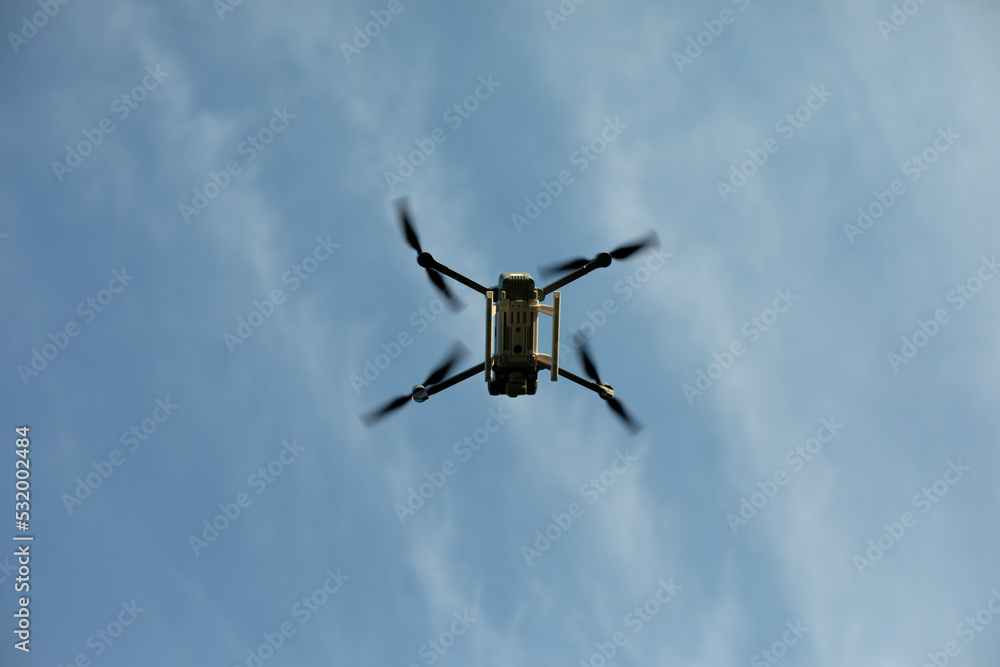 Drone in sky. Quadro copter flies in air. Surveillance from height ...