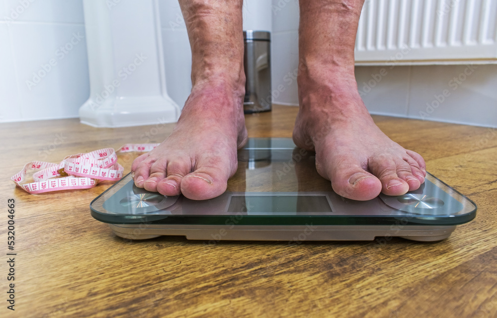 Weight watching, scale measurement. Standing on the bathroom scales and ...