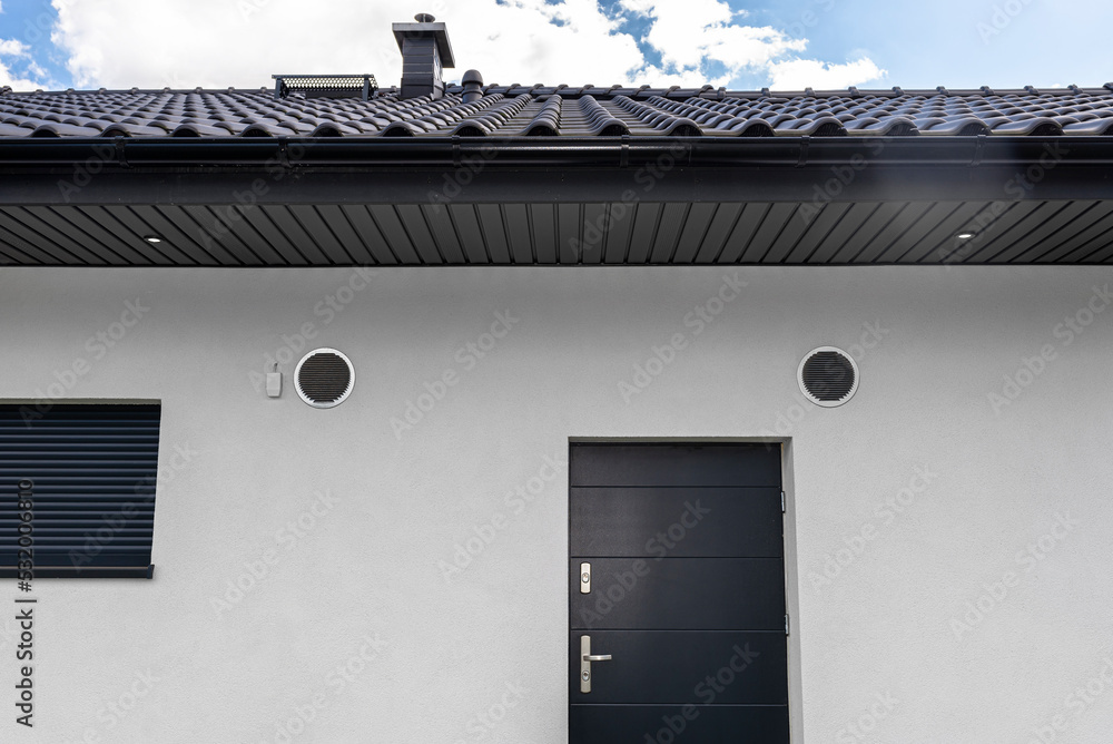 Air intake and exhaust in the wall of a single family house for ...
