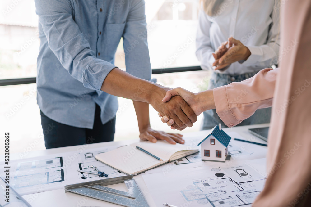Architect and engineer work together and shaking hands to welcome home ...