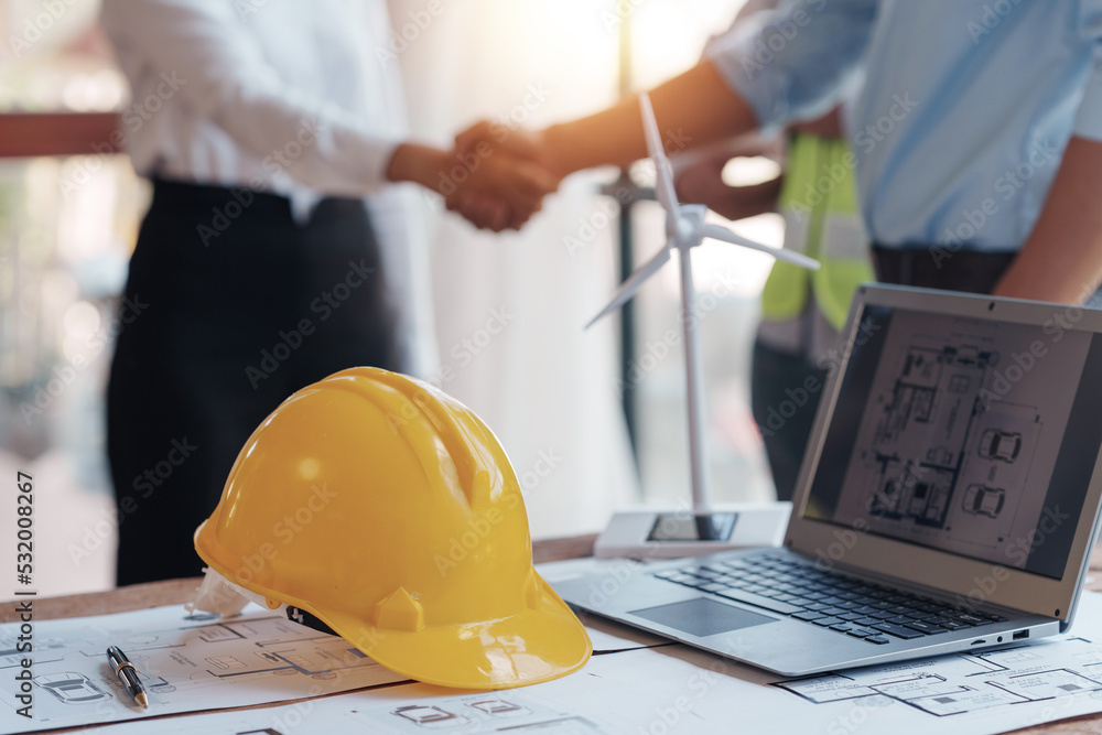 Architect and engineer work together and shaking hands to welcome home ...