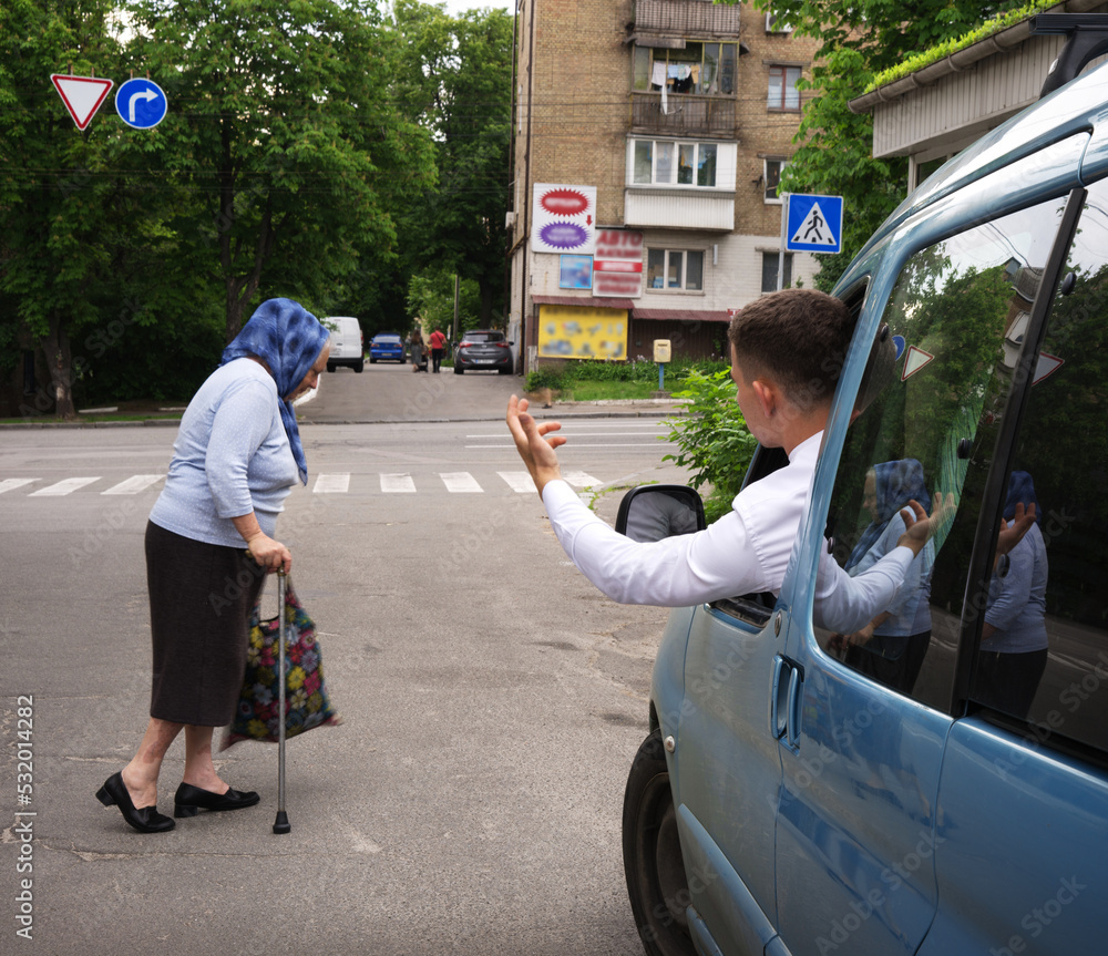 Angry car driver yelling at pedestrian Stock Photo | Adobe Stock