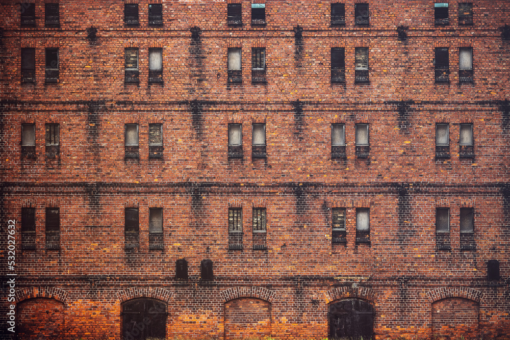 Wall of the old factory building of red brick with narrow windows Stock ...