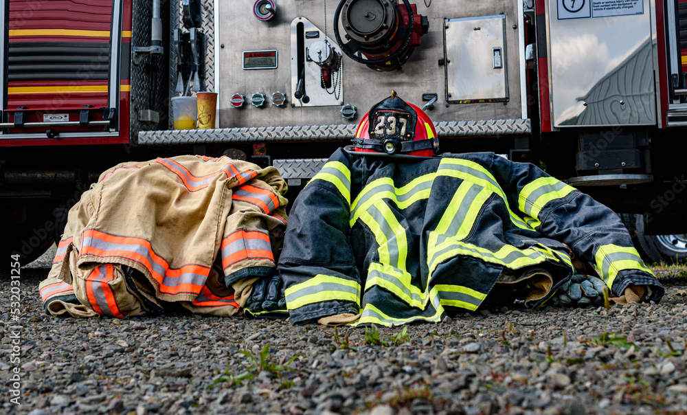 Fotografia do Stock: Two firefighter coats and one helmet are laid in ...