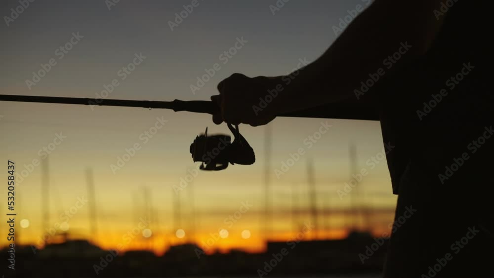 Fisherman holding fishing rod with reel close-up. Angler with rod ...