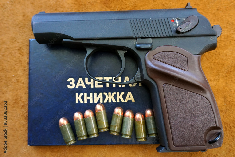 Russian students grade book and Soviet Makarov pistol with bullets in ...