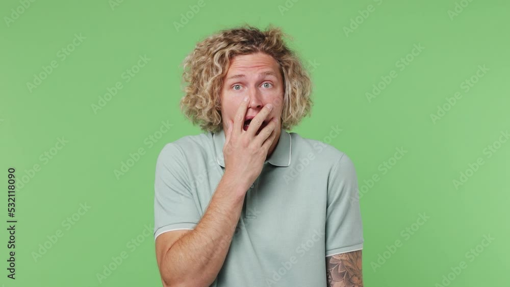 Young scared shocked blond man 20s he wear blue t-shirt look camera ...