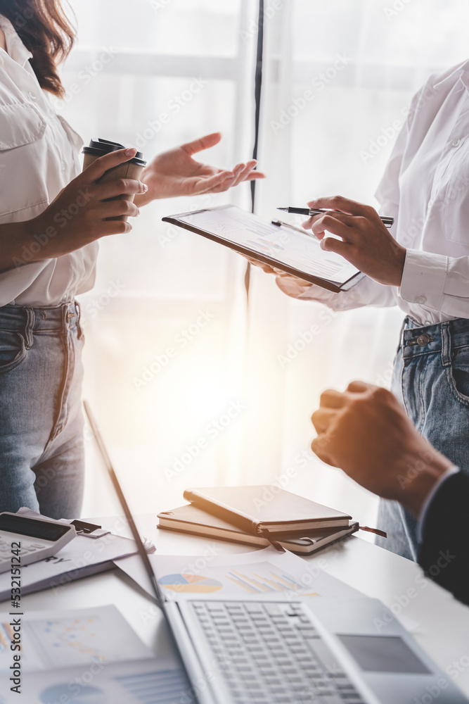 Young colleagues discussing business and price chart analyzes business ...