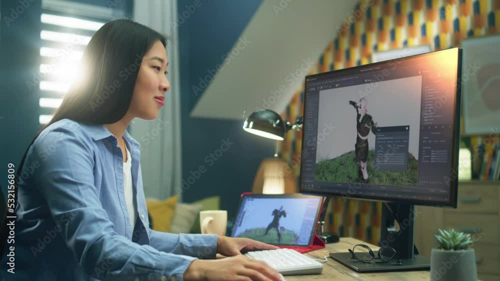 Asian female 3D designer making animation for video game character ...