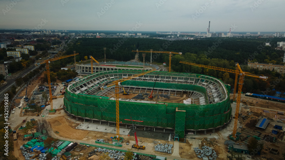 Building a stadium in a big city. Construction site among urban areas ...